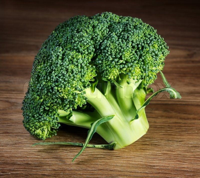 Raw broccoli on wooden background | Stock Bild | Colourbox
