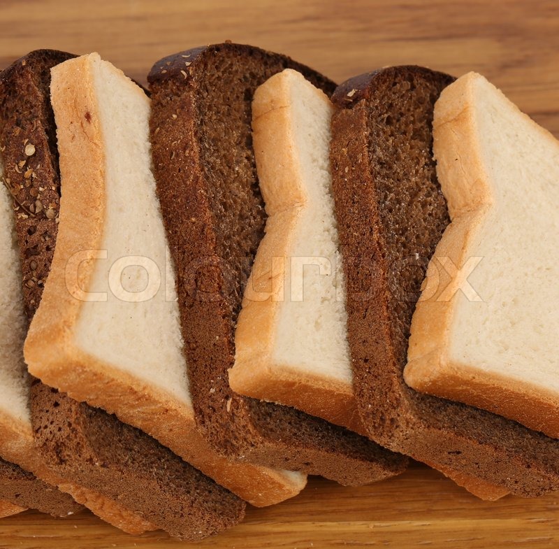 White and brown loaf of bread on wooden ... | Stock Photo | Colourbox