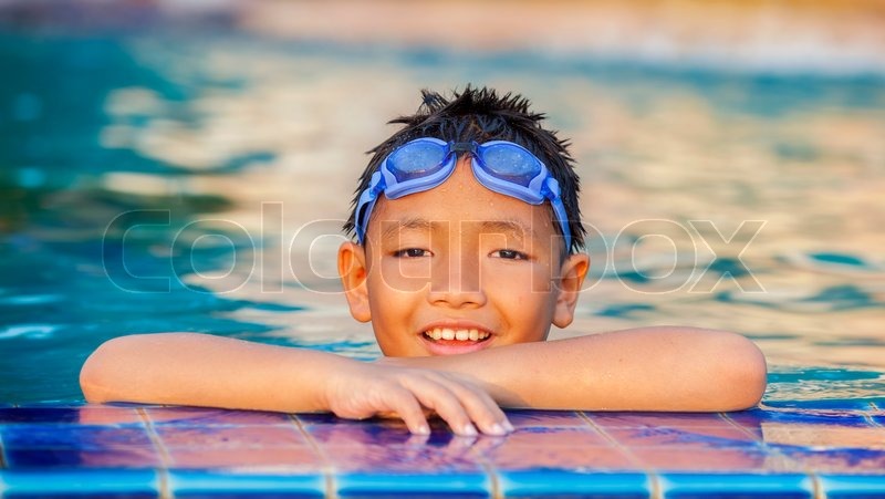 Little boy playing in swimming pool | Stock image | Colourbox