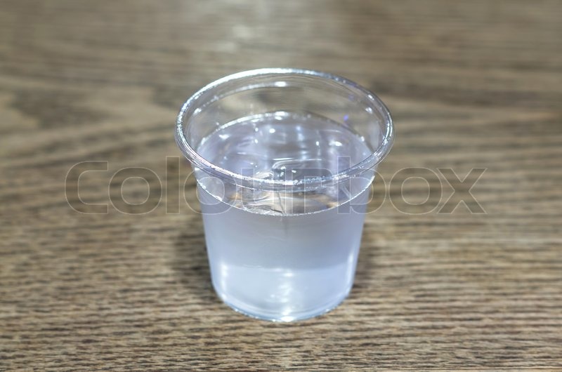 Water plastic cup on wood table | Stock image | Colourbox