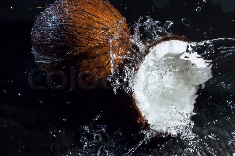Cracked coconut with big splash on ... | Stock image | Colourbox