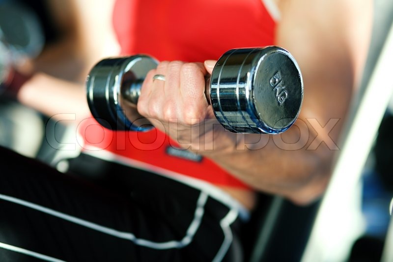 Woman lifting hand weights in a gym, ... | Stock image | Colourbox