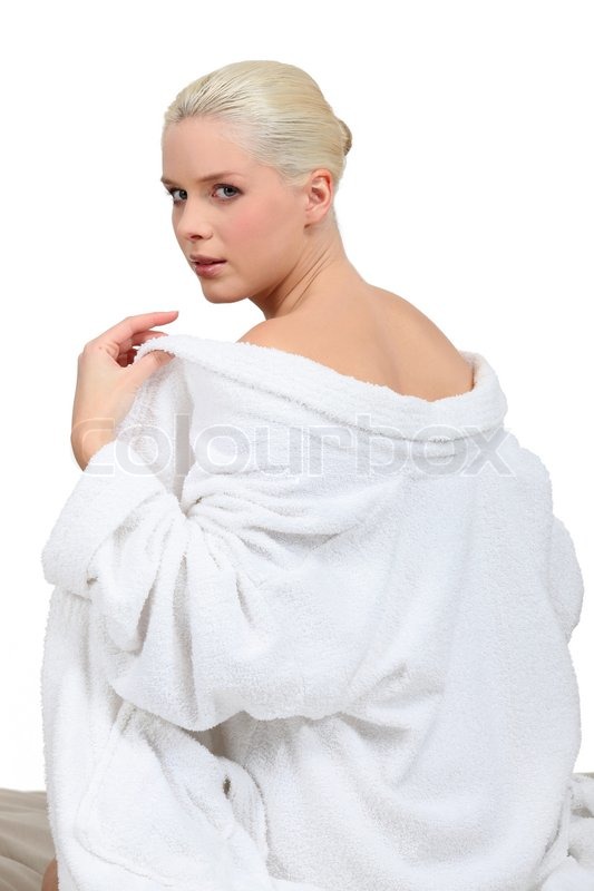 Woman taking off robe | Stock image | Colourbox