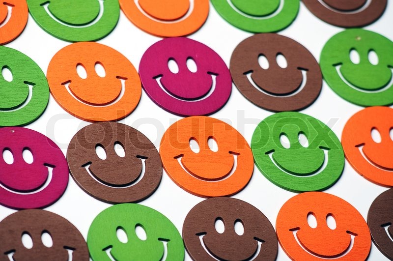 Smiling wooden multi colored emoticons ... | Stock image | Colourbox