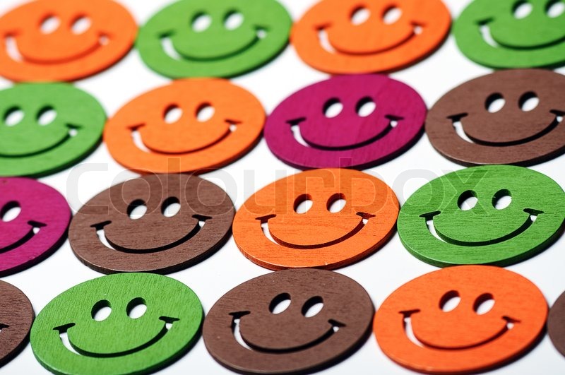 Smiling wooden multi colored emoticons ... | Stock image | Colourbox