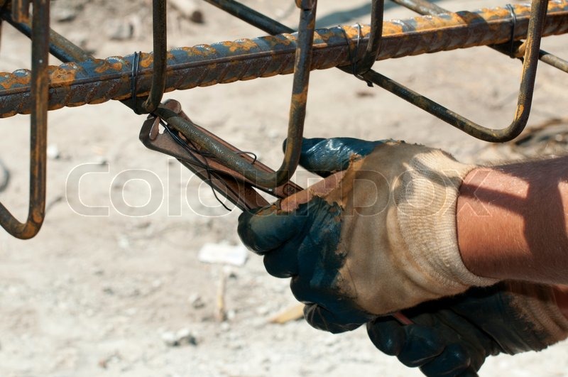 Construction worker ties reinforcing ... | Stock Photo | Colourbox