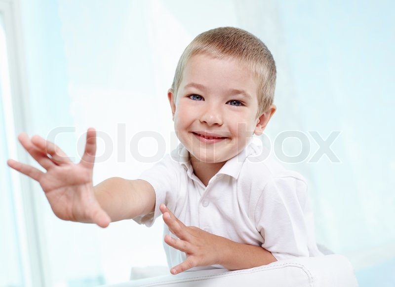Little boy reaching out towards the ... | Stock Photo | Colourbox
