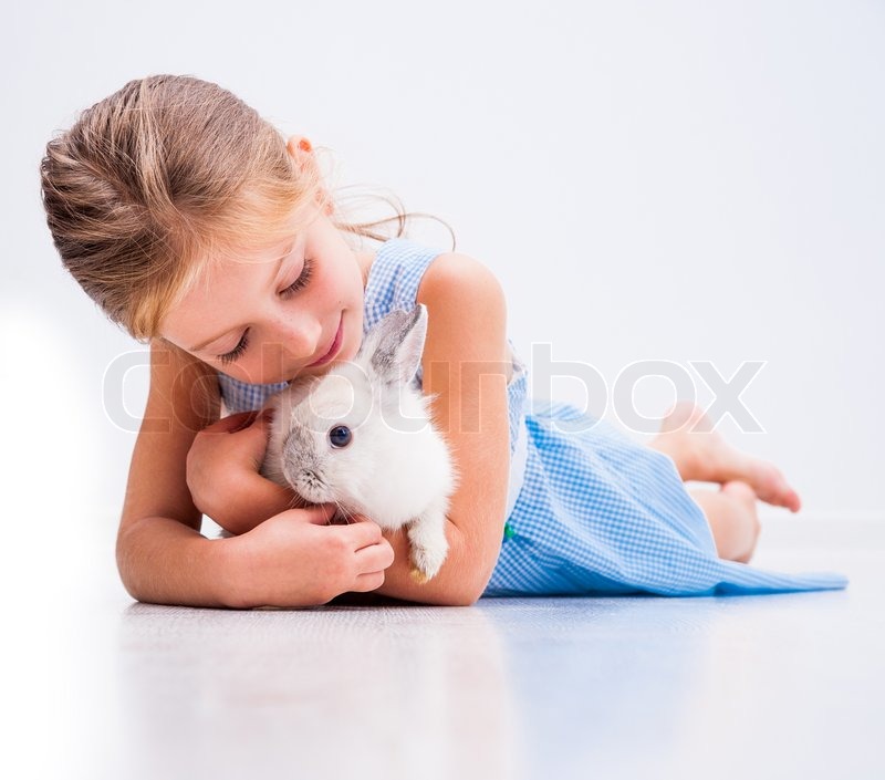 Cute little girl with her rabbit on ... | Stock image | Colourbox