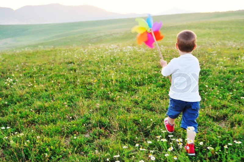 Little happy child play with windmil ... | Stock image | Colourbox