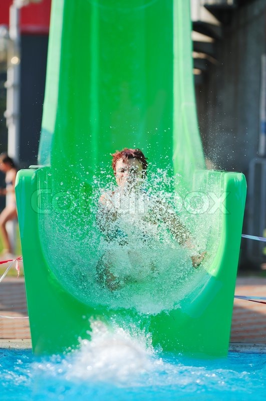 Happy girl have fun on water slide at ... | Stock image | Colourbox