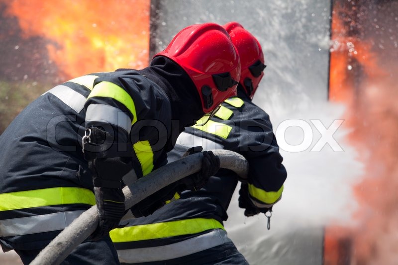 Firefighters fighting fire | Stock image | Colourbox
