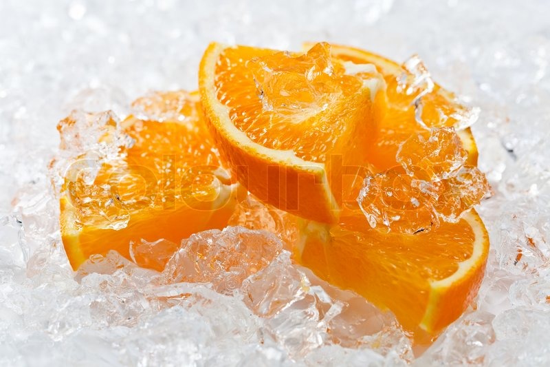Slices of orange with ice | Stock Photo | Colourbox