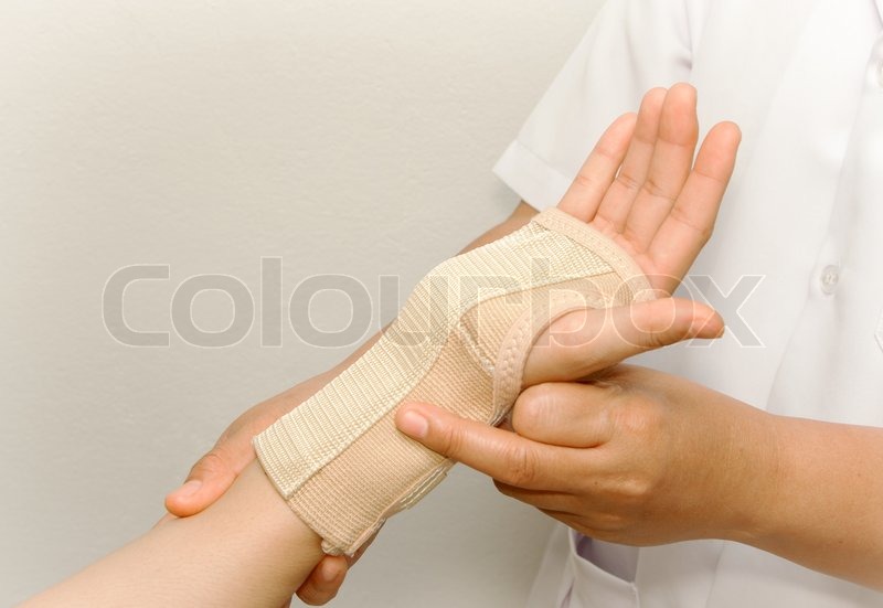 Doctor checkup the patient's arm on the ... | Stock image | Colourbox
