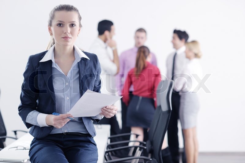 Successful business woman standing with ... | Stock image | Colourbox
