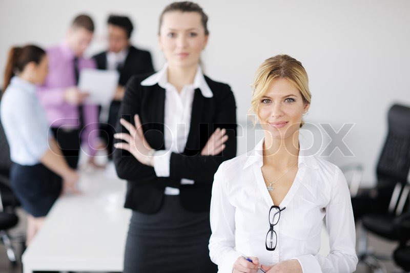 Successful business woman standing with ... | Stock image | Colourbox