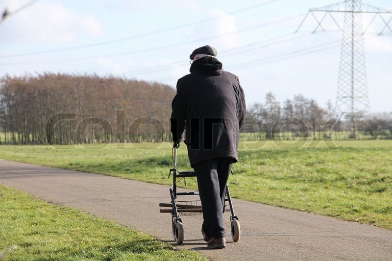 Walking man with his walker. | Stock image | Colourbox