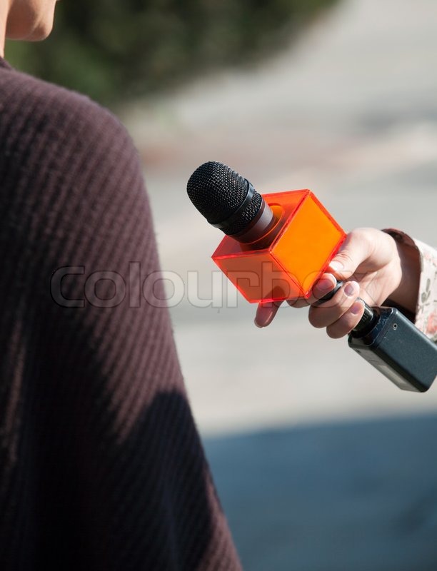 Journalist hand holding a microphone ... | Stock image | Colourbox