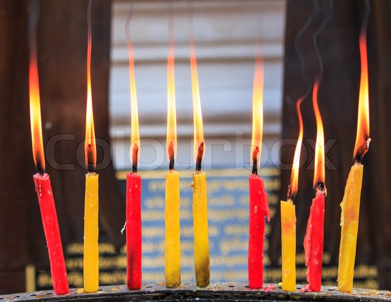 Lighting prayer candle offering, ... | Stock image | Colourbox