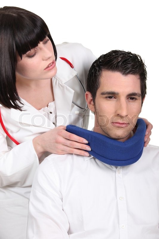 Doctor putting a neck brace on her ... | Stock image | Colourbox
