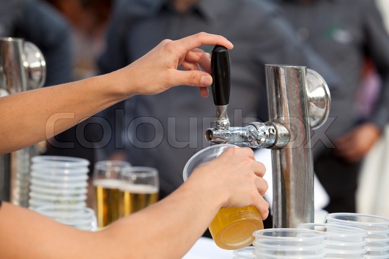 A beer being poured from a beer tap | Stock image | Colourbox