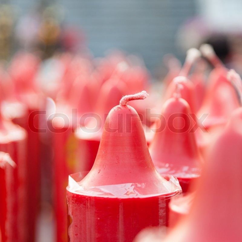 Big red candles lined up in a row a ... | Stock image | Colourbox