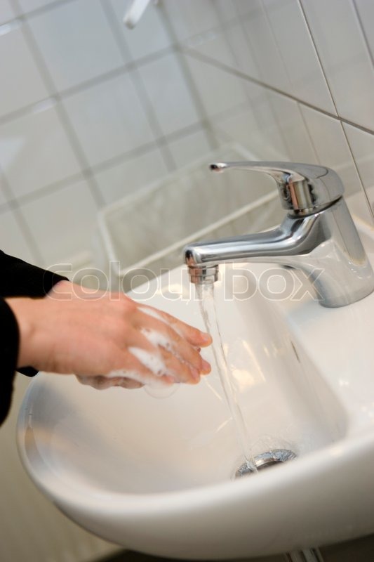 Washing hands at a toilet sink | Stock image | Colourbox