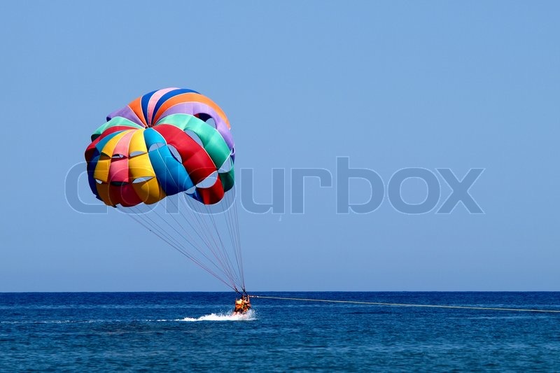 Two people parachuting into the sea | Stock image | Colourbox