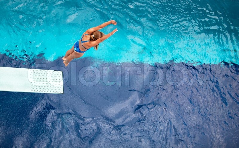 Female springboard diver diving into ... | Stock image | Colourbox