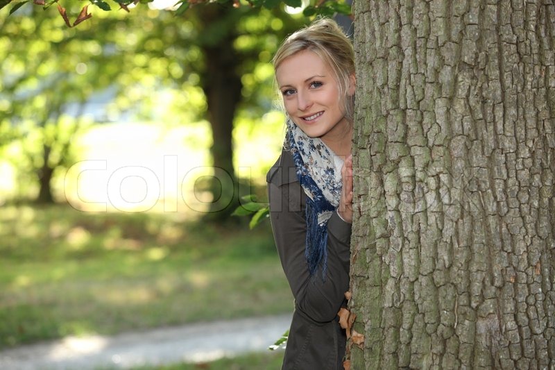 Woman Hiding Behind Tree