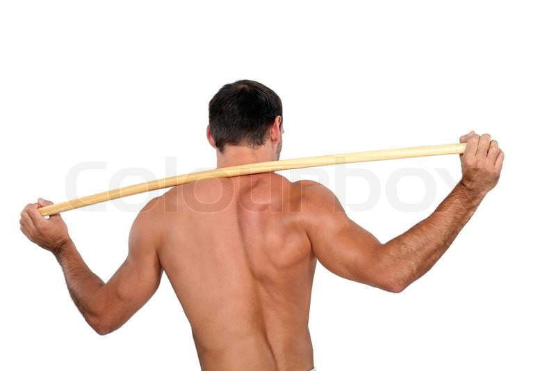 Man stretching with wooden pole | Stock image | Colourbox