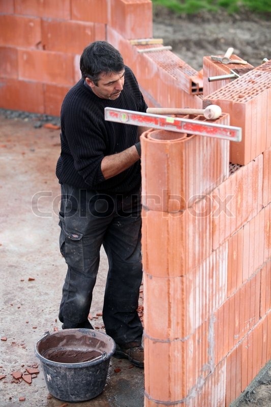 Mason working on site alone | Stock image | Colourbox