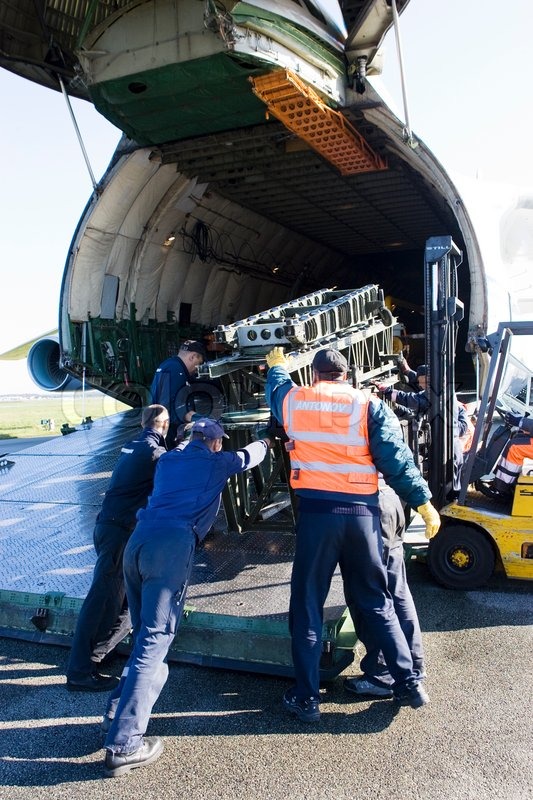 Men carrying cargo inside a plane in an ... | Stock image | Colourbox