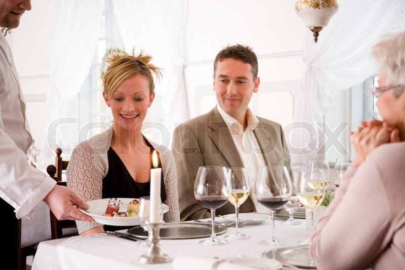 A waiter serving the restaurant guests ... | Stock image | Colourbox
