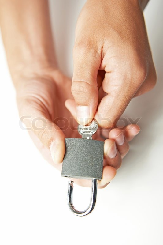 Hands holding a padlock and key | Stock foto | Colourbox