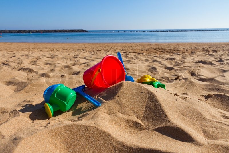 Beach toys in sand on sea shore at ... | Stock image | Colourbox