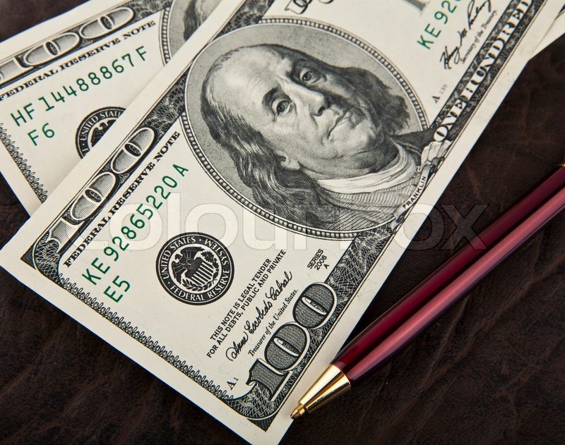 Dollars and pen on a white background | Stock image | Colourbox