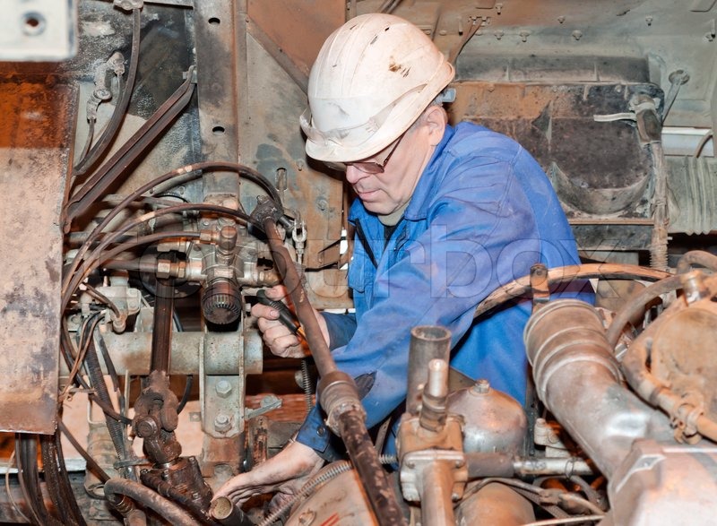 The mechanic dressed in dirty overalls ... | Stock image | Colourbox