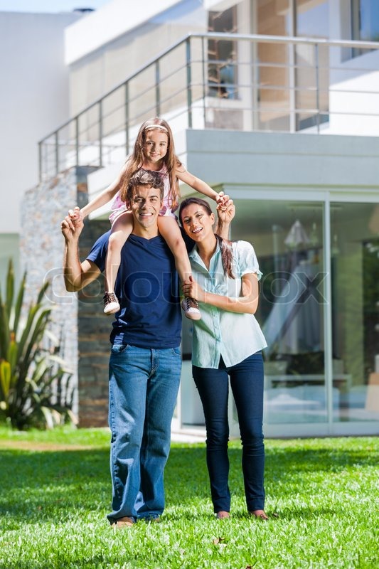 Happy family smile in front of house ... | Stock image | Colourbox