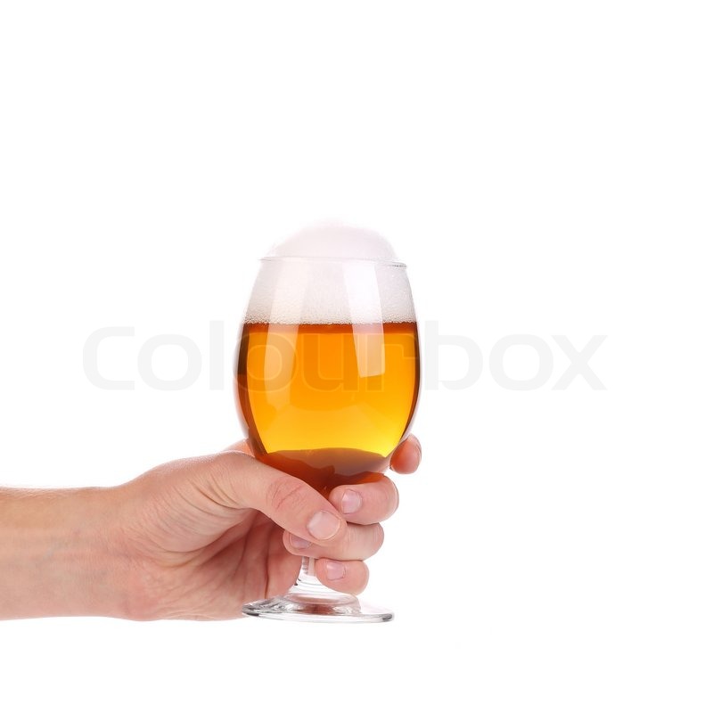 Glass of beer in hand. Isolated on a ... | Stock image | Colourbox
