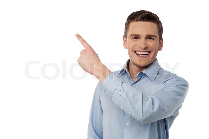 Smiling man pointing his finger on ... | Stock image | Colourbox