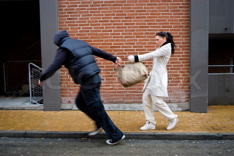 A male mugger grabbing a bag from a ... | Stock image | Colourbox