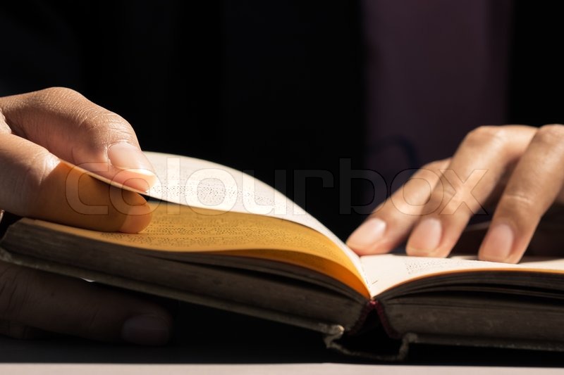 Closeup finger on the old book for ... | Stock image | Colourbox