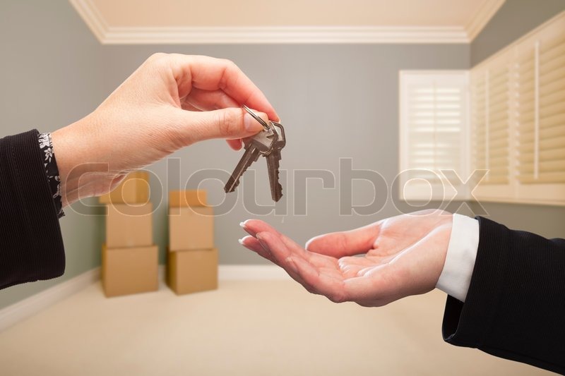 Woman Handing Over the House Keys To A ... | Stock image | Colourbox